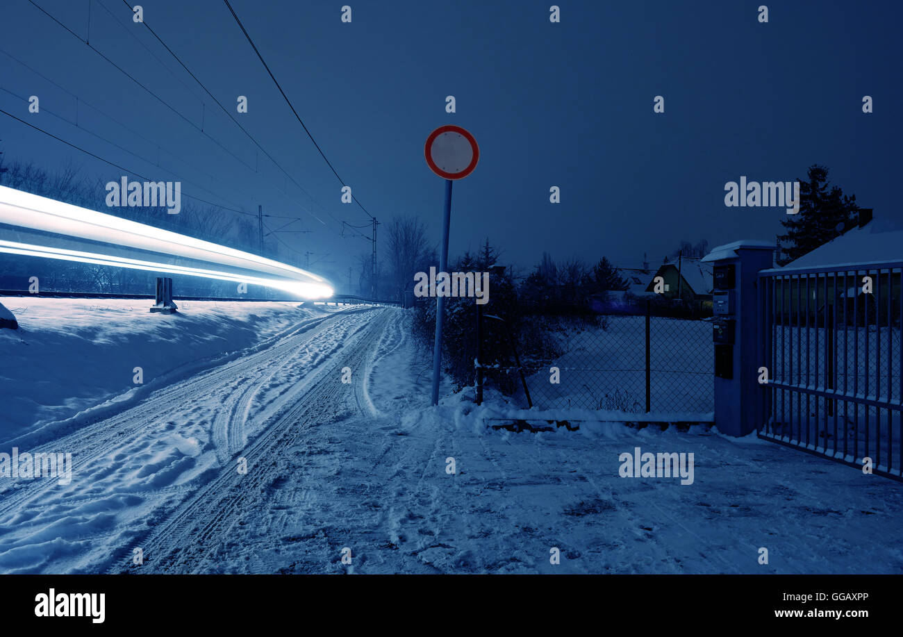 Winter night with a train light strip Stock Photo - Alamy