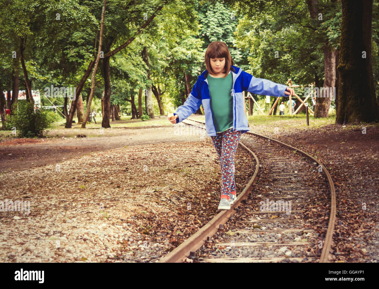 A little girl balancing on the rails Stock Photo - Alamy