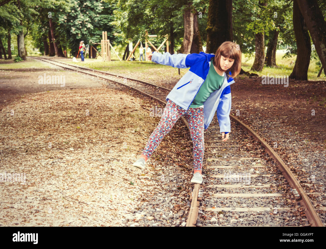 A little girl balancing on the rails Stock Photo - Alamy