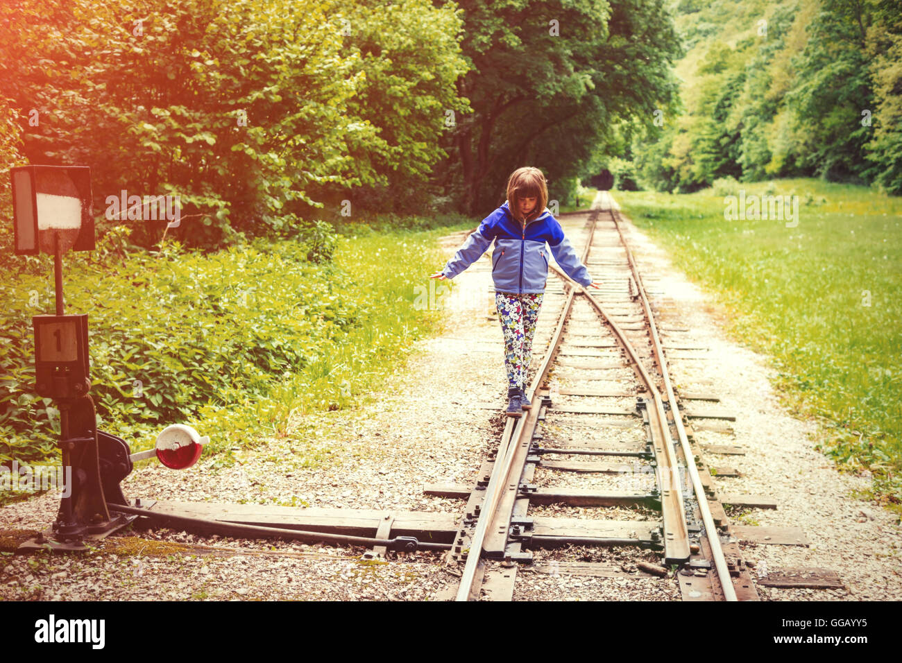 A little girl balancing on the rails Stock Photo - Alamy