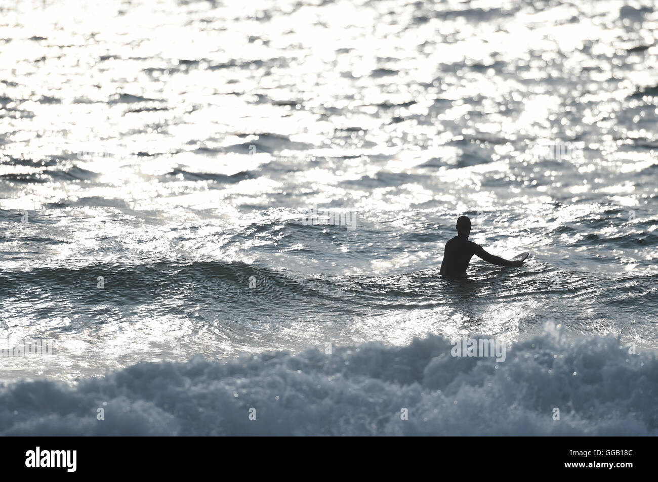 surfer sitting on board waiting for a wave Stock Photo - Alamy