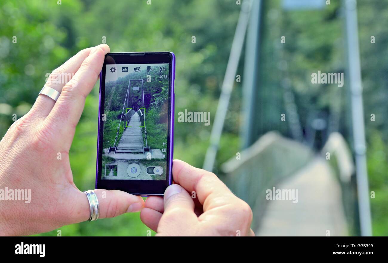 View over the mobile phone display during taking a picture of bridge in ...