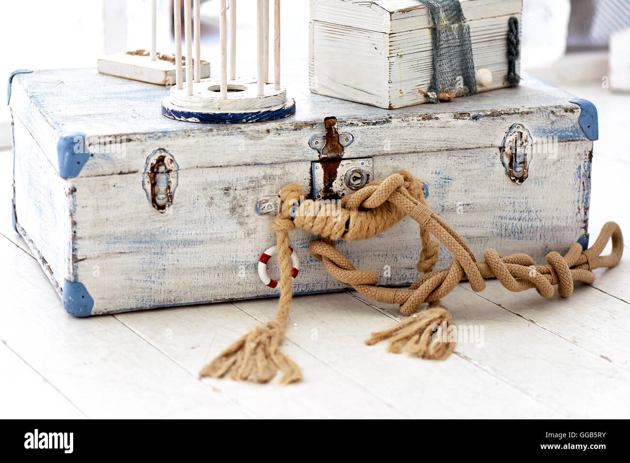 Suitcase in Navy style, with rope tied in a knot Stock Photo - Alamy