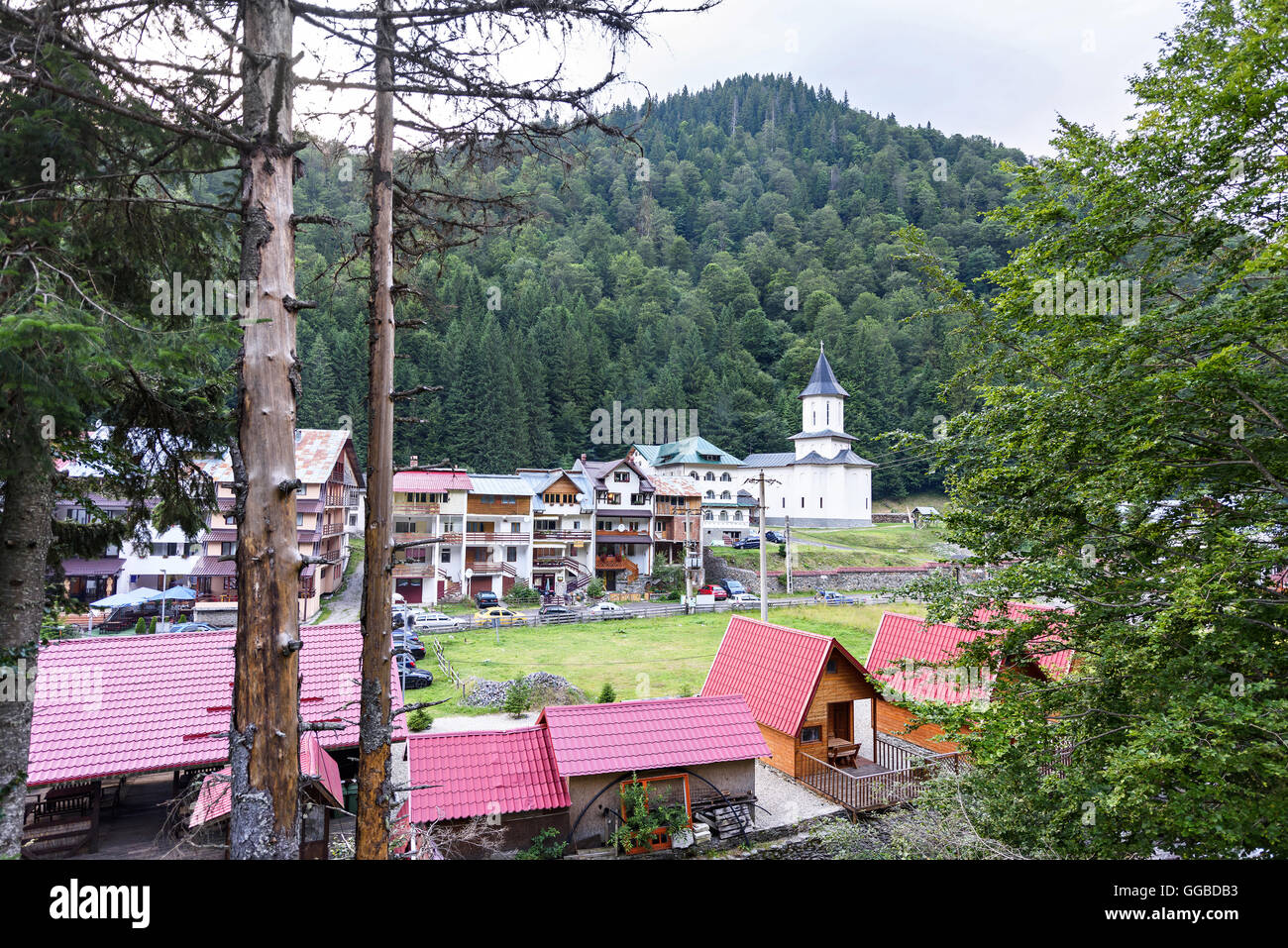 Photo of green peaks and a touristic village with blue church in ...