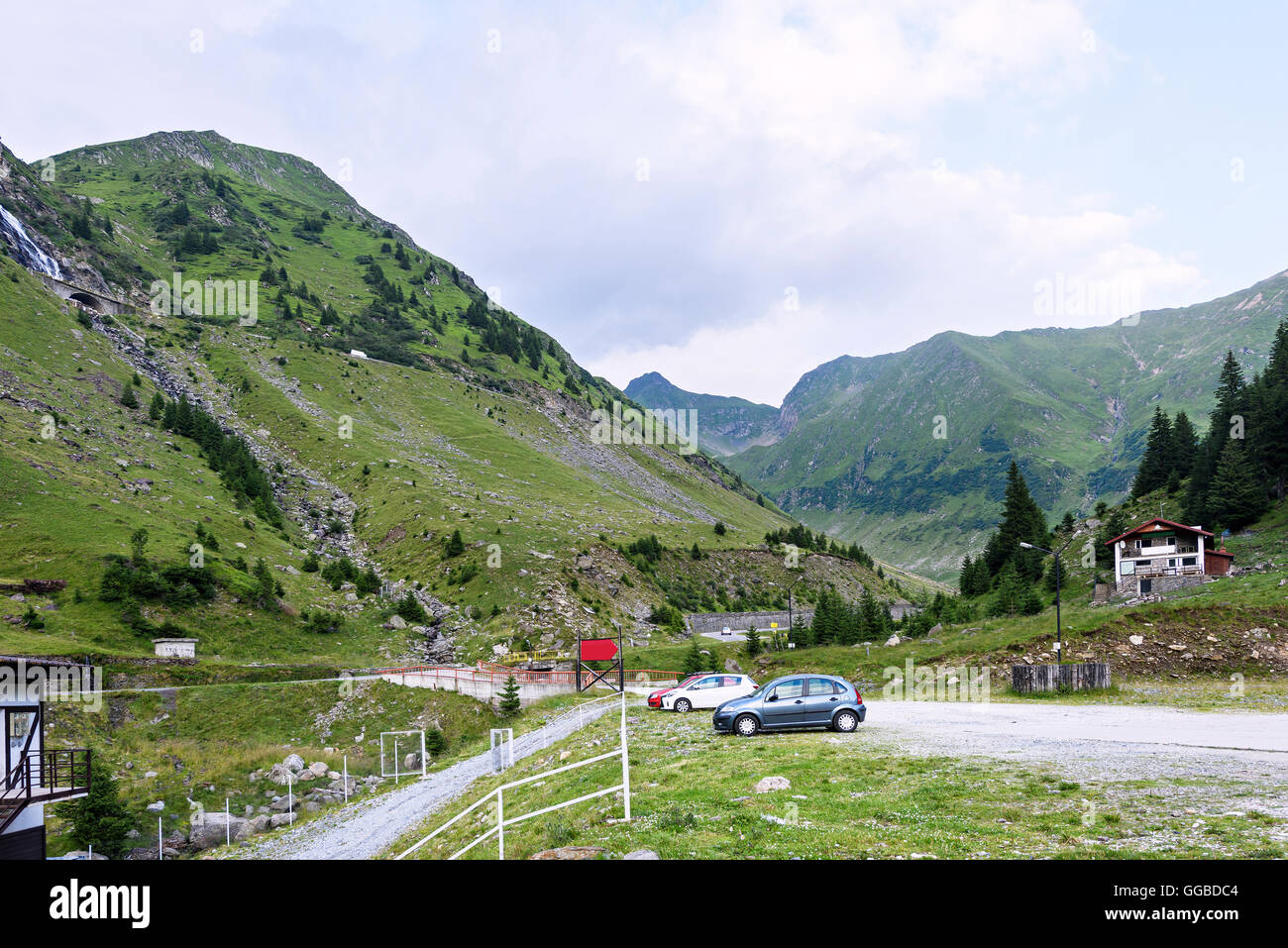 Photo of green capra peak, a small river and a road in fagaras ...