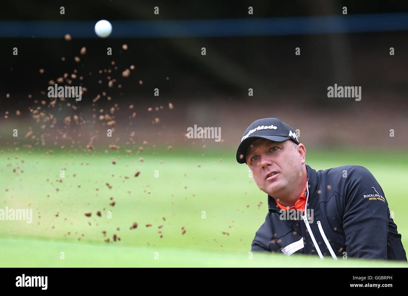 Graeme Storm chips out of the bunker on the 11th green during day one ...