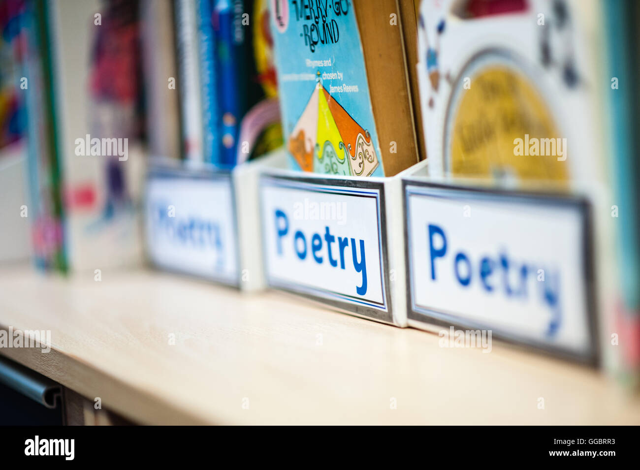 Primary school poetry books on shelves in the library for children to ...