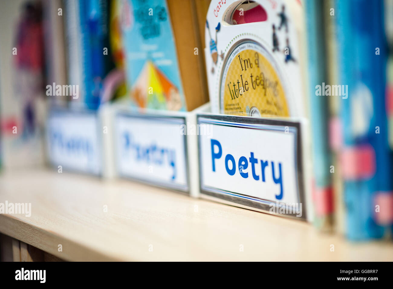 Primary school poetry books on shelves in the library for children to ...