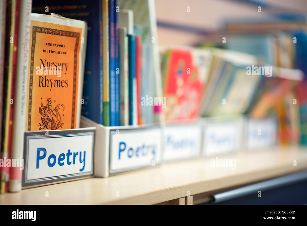 Primary school poetry books on shelves in the library for children to ...