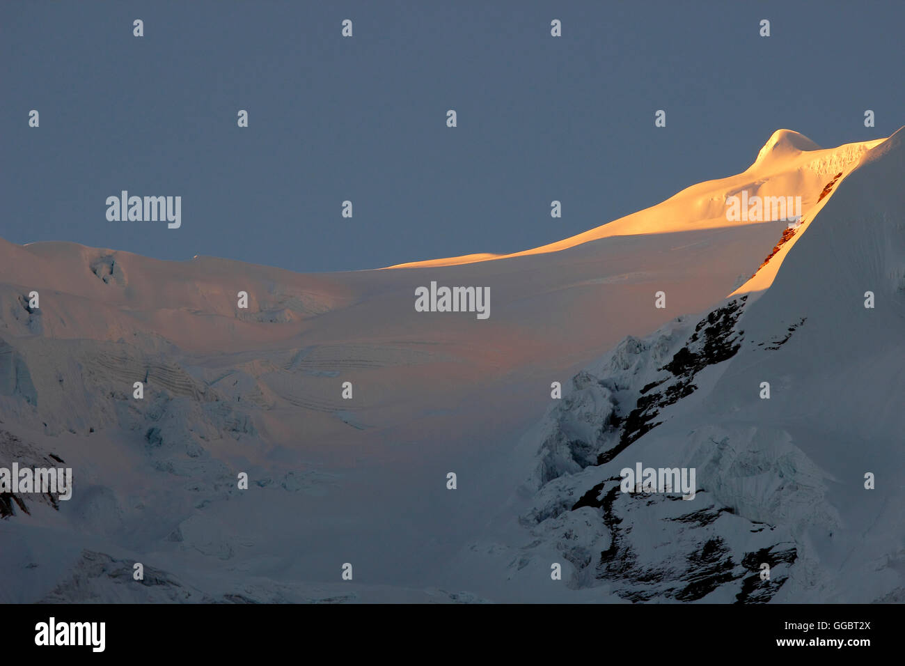 First light catches snow fields and glacier of Mera Peak Stock Photo ...