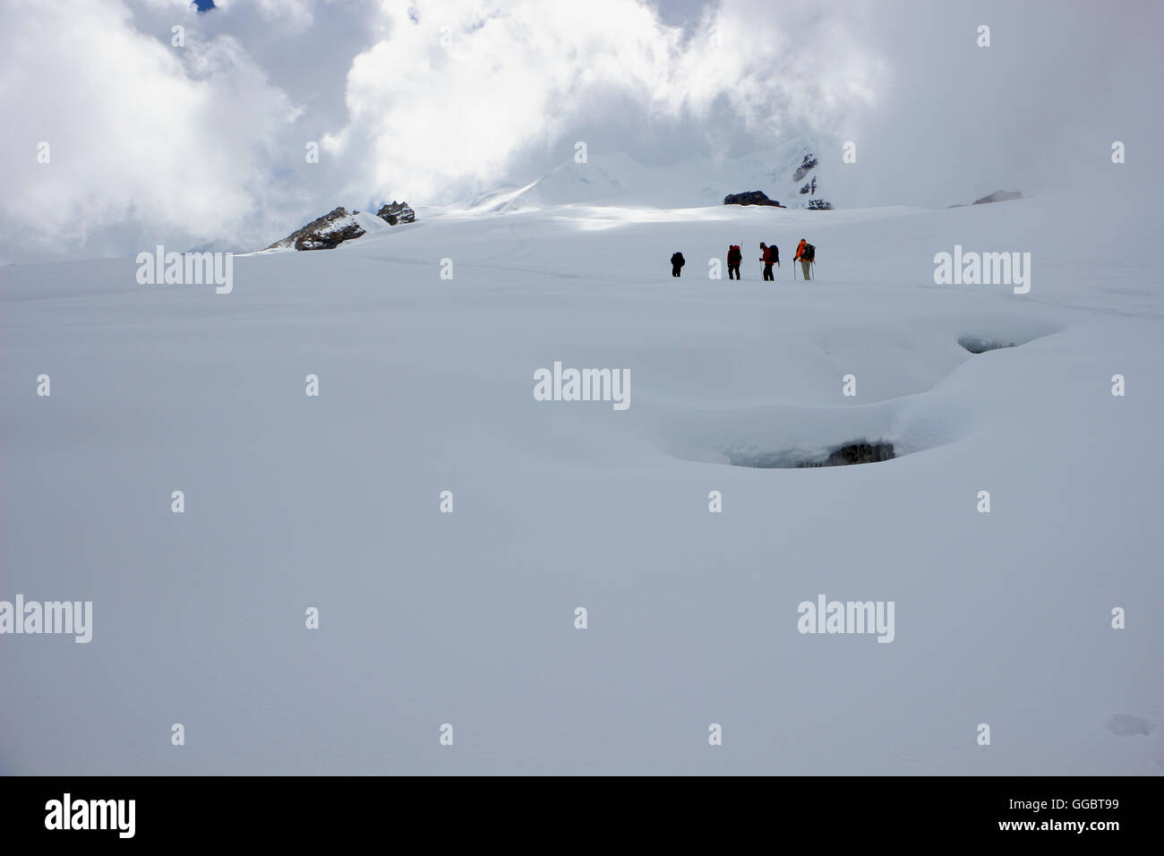 Climbers passing Crevices in snow fields on route to Mera peak high ...