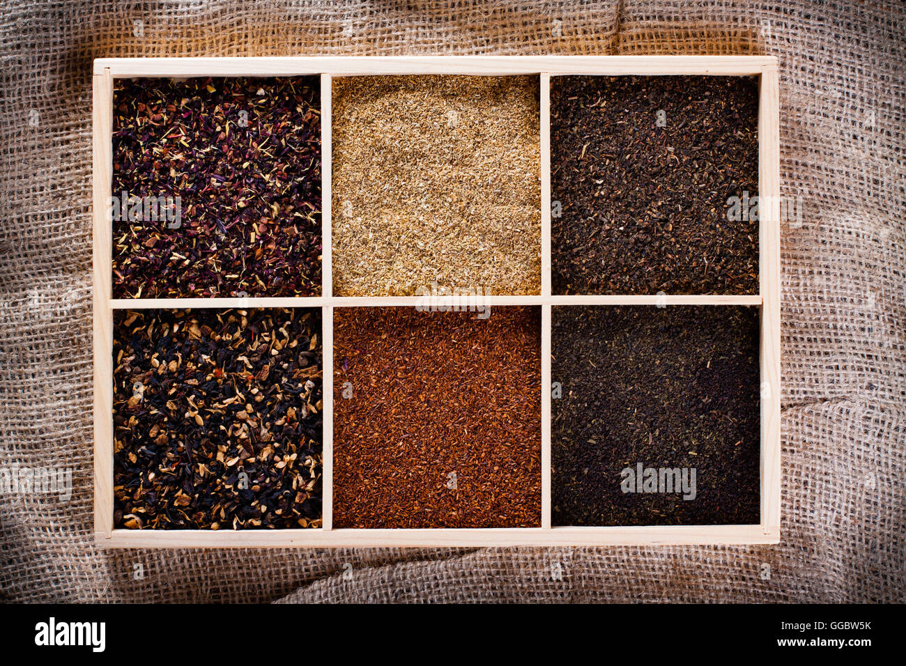 Mixed tea in a wooden box on jute background Stock Photo - Alamy