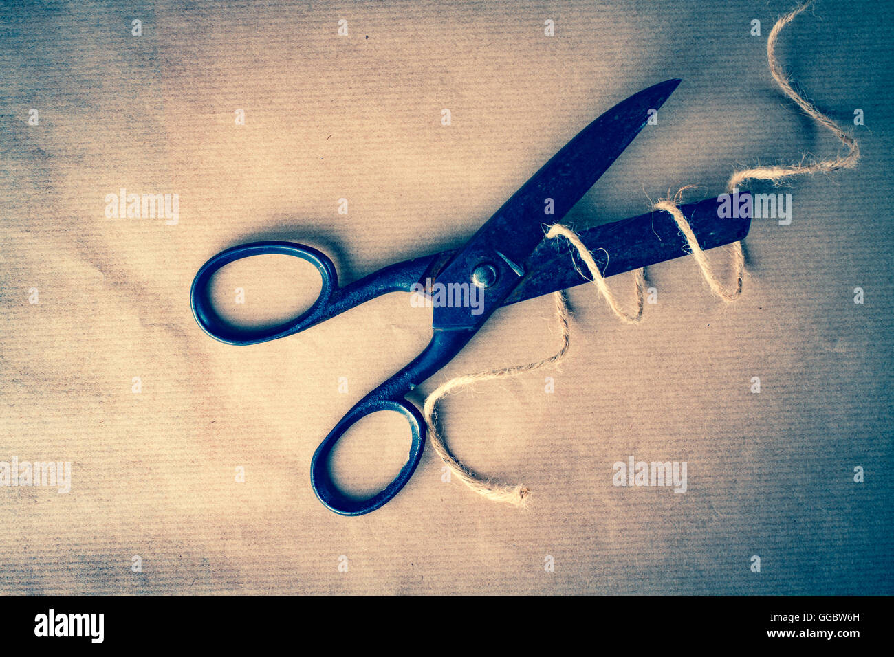 Jute twine and old scissors on wrapping paper background Stock Photo ...