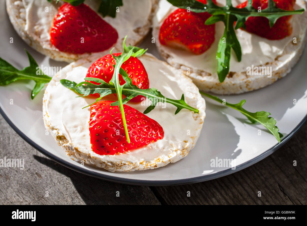 Multigrain rice cakes with strawberries fruit , soft mascarpone cheese ...