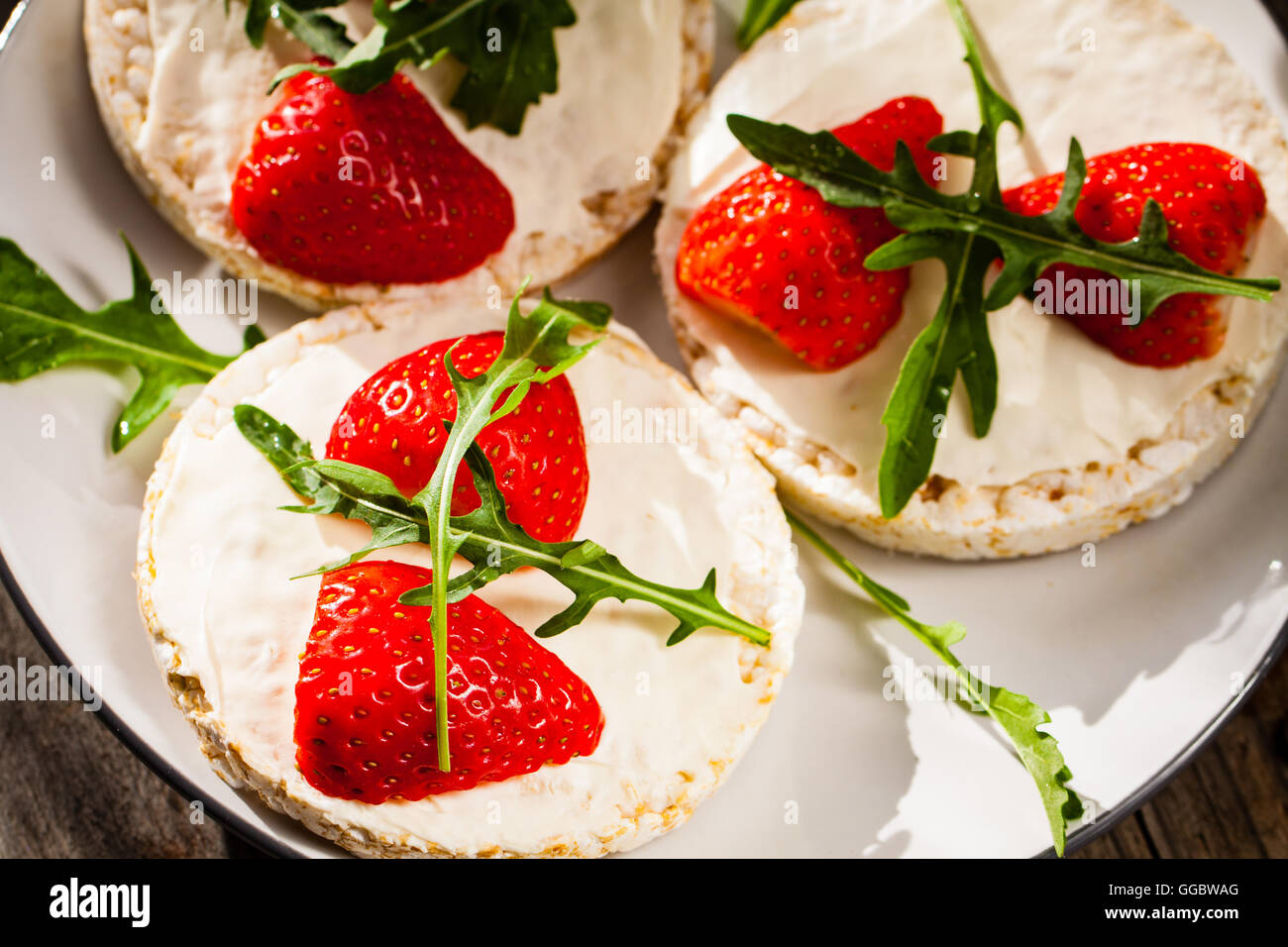 Multigrain rice cakes with strawberries fruit , soft mascarpone cheese ...