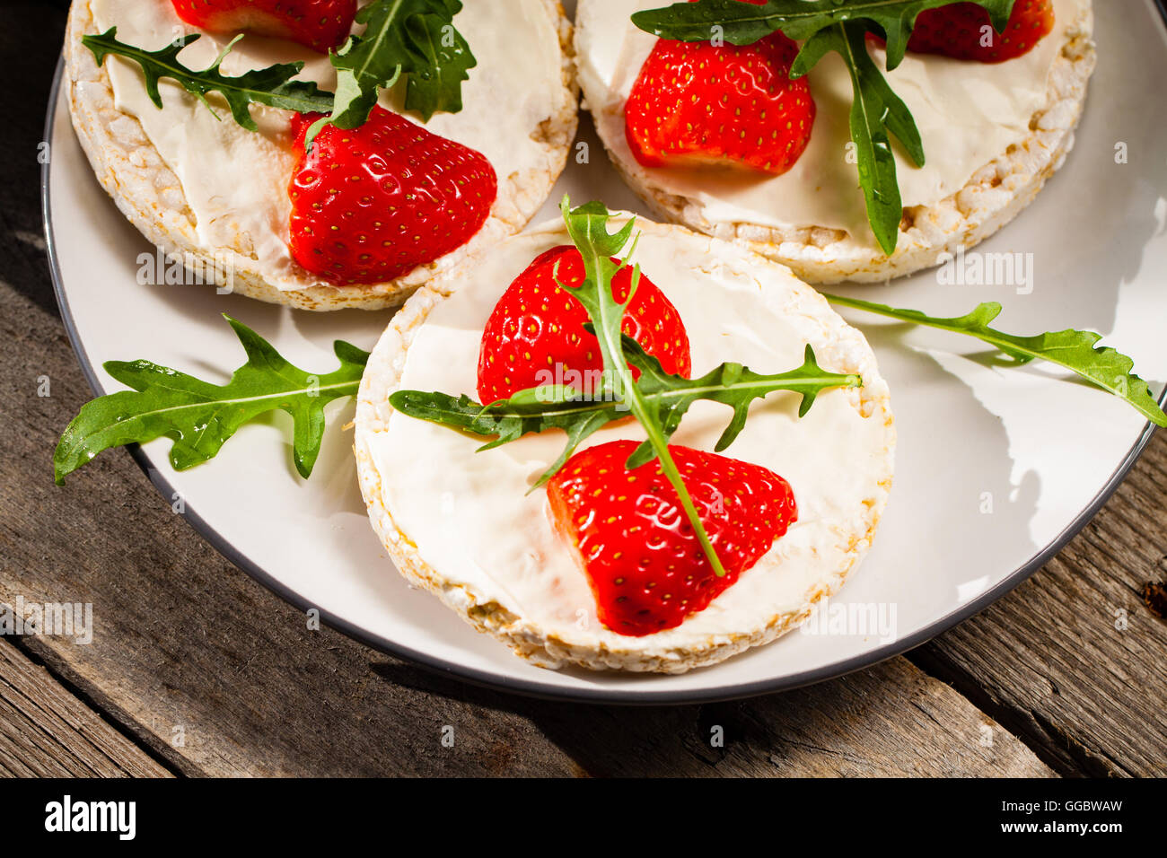 Multigrain rice cakes with strawberries fruit , soft mascarpone cheese ...
