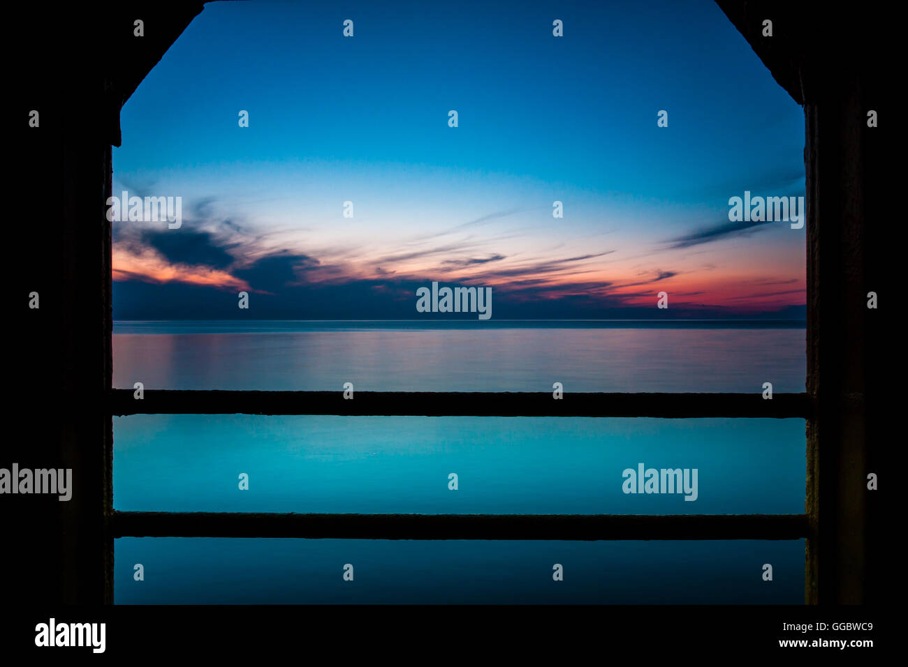 View of sea horizon, while blue hour, border shadow on bridge railing ...
