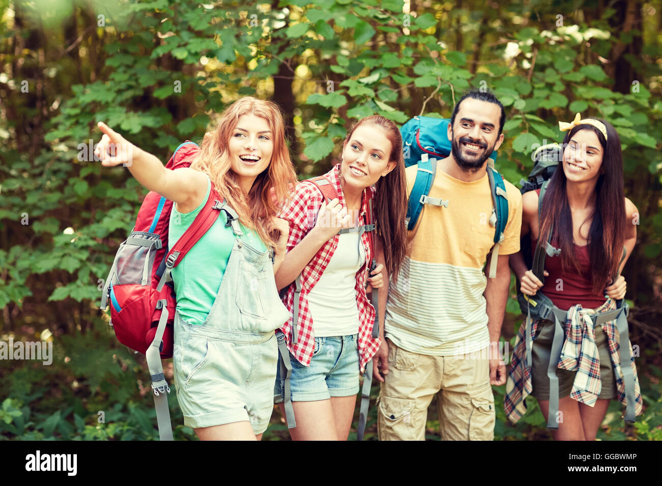 group of smiling friends with backpacks hiking Stock Photo - Alamy
