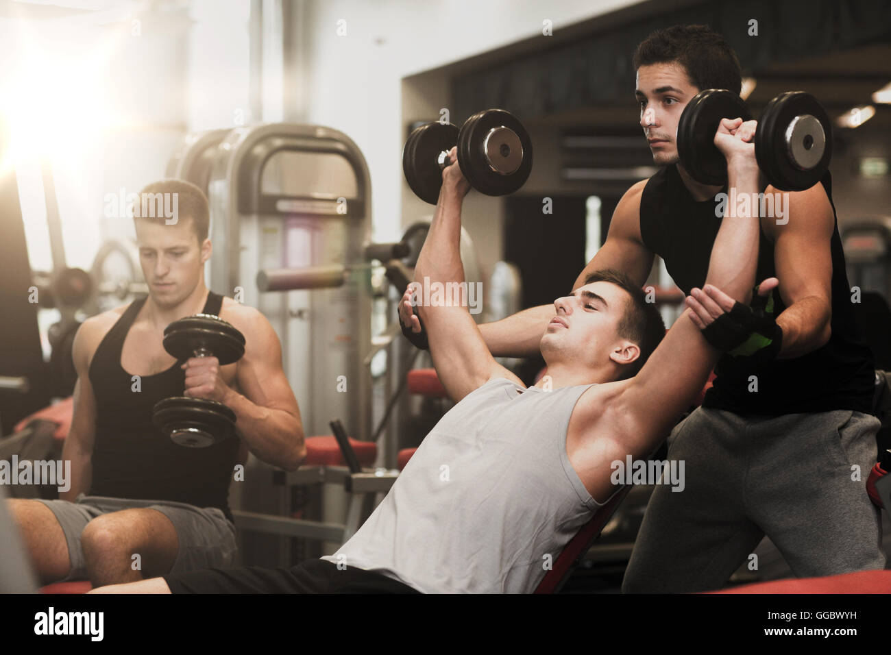 group of men with dumbbells in gym Stock Photo - Alamy