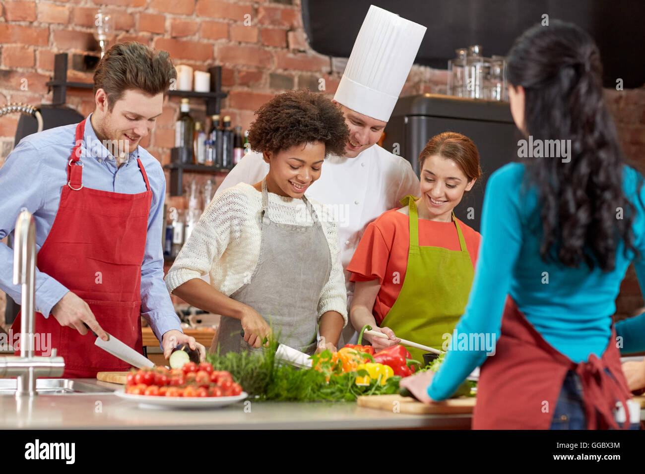 happy friends and chef cook cooking in kitchen Stock Photo - Alamy