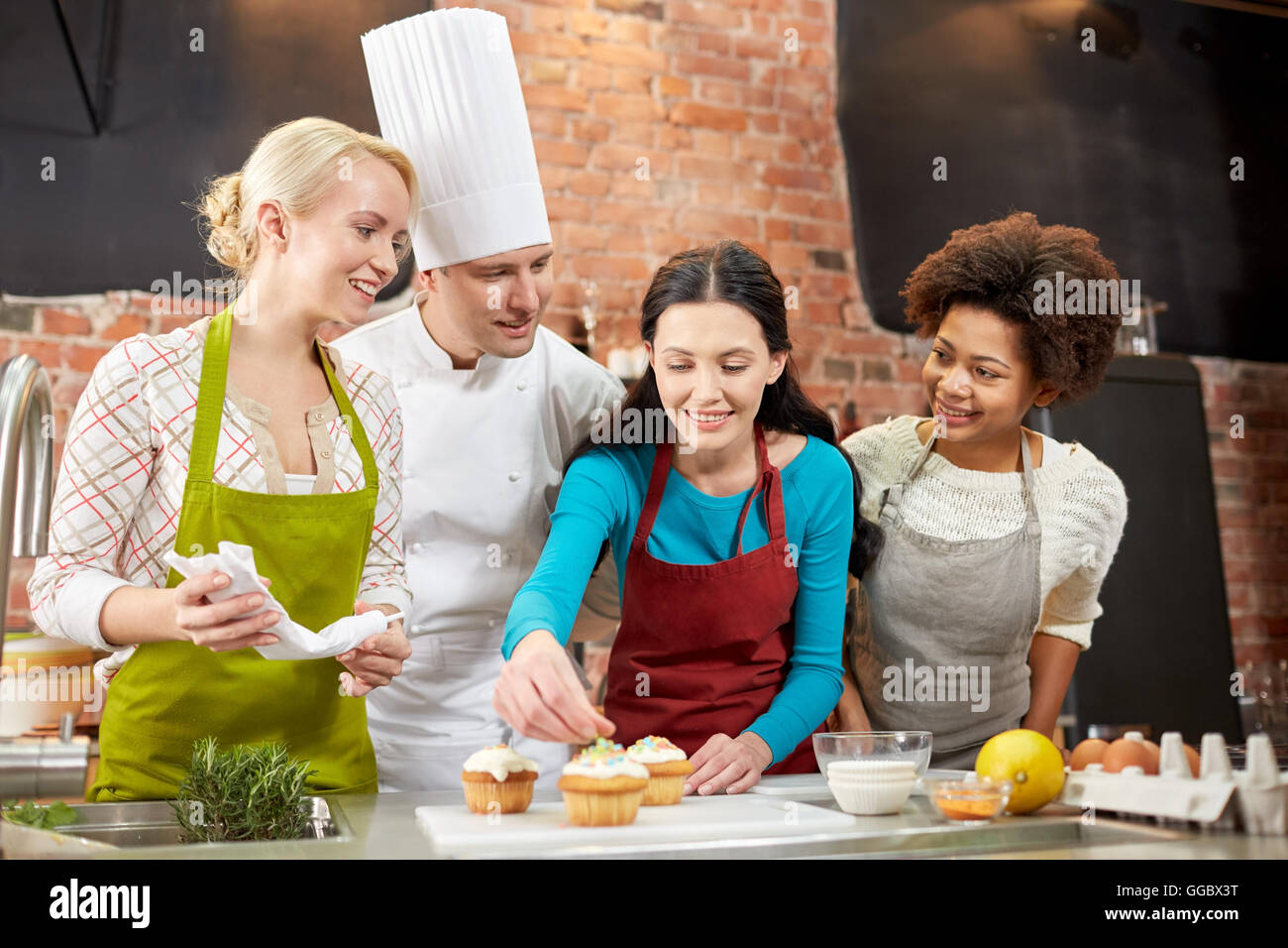 happy women and chef cook baking in kitchen Stock Photo - Alamy