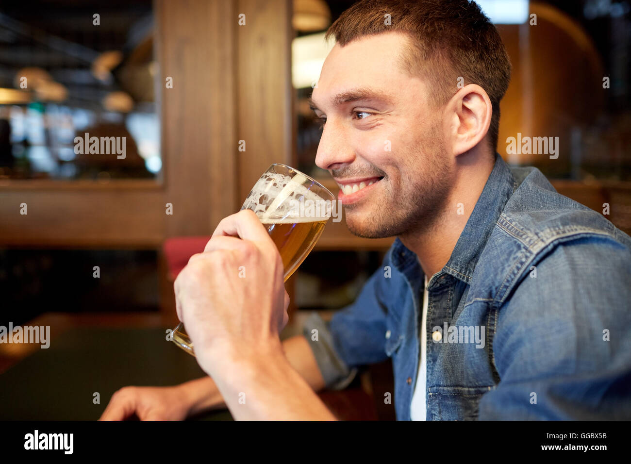 happy man drinking draft beer at bar or pub Stock Photo - Alamy