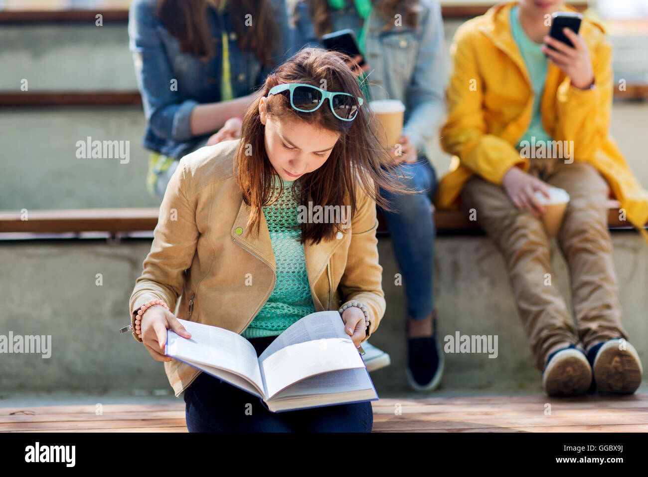 high school student girl reading book outdoors Stock Photo - Alamy