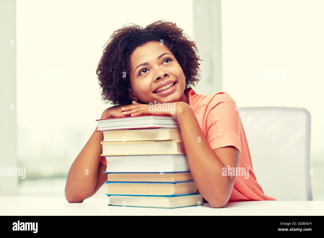 happy african student girl with books at home Stock Photo - Alamy
