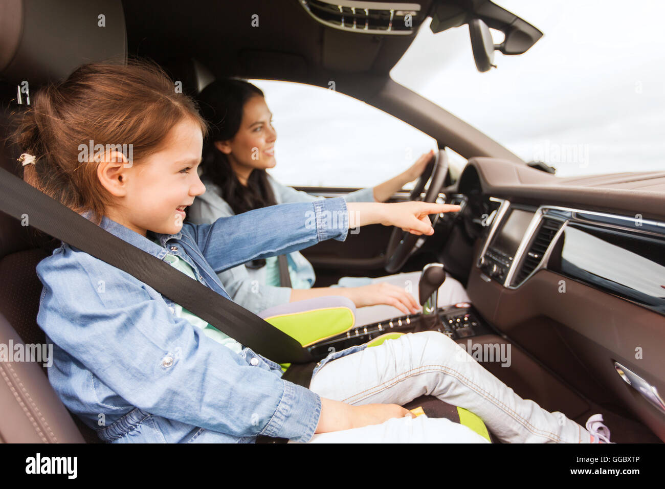 happy woman with little child driving in car Stock Photo - Alamy