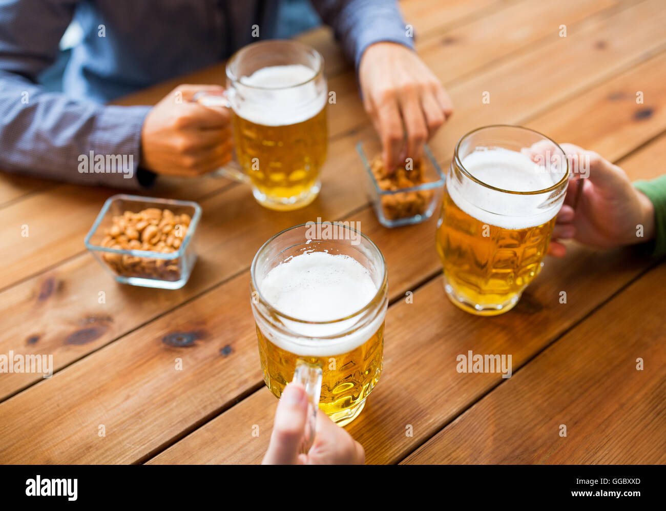 Hands holding beer mugs hi-res stock photography and images - Alamy