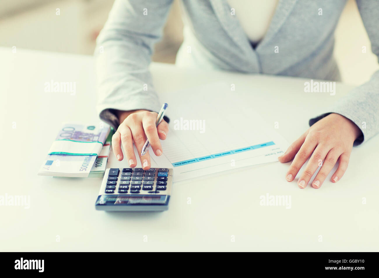 close up of hands counting money with calculator Stock Photo - Alamy