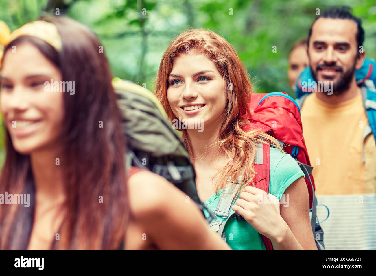 group of smiling friends with backpacks hiking Stock Photo - Alamy