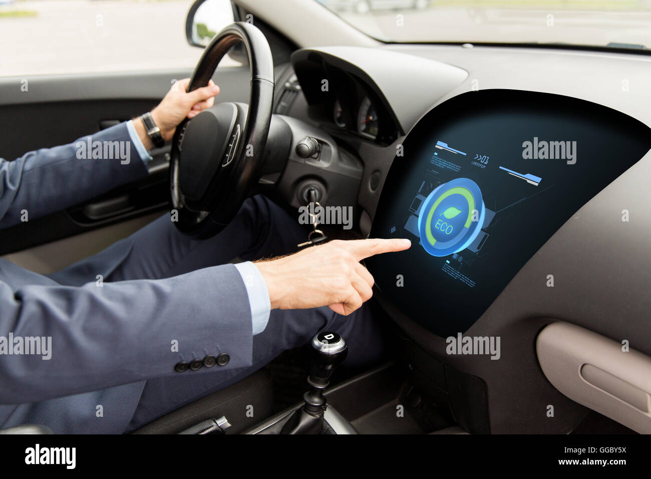 man driving car with eco mode on board computer Stock Photo - Alamy