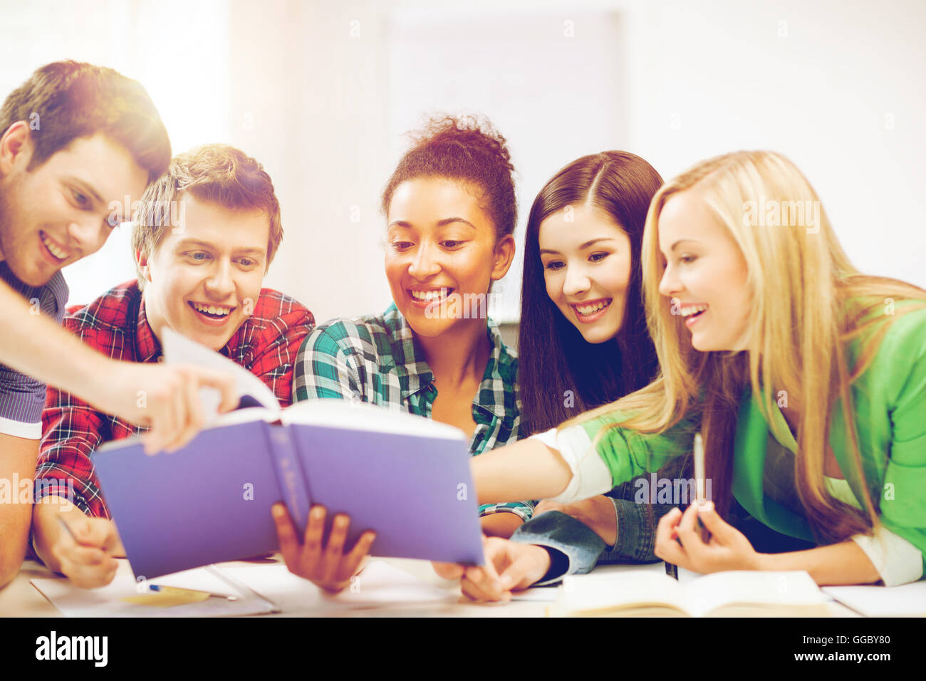 students reading book at school Stock Photo - Alamy