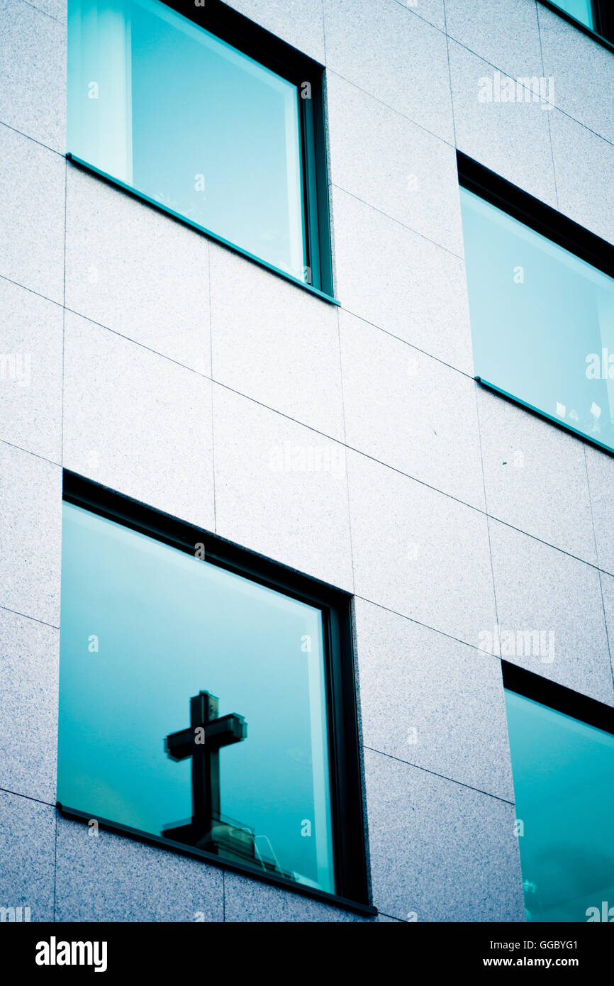cross reflected into a window of a modern building Stock Photo - Alamy