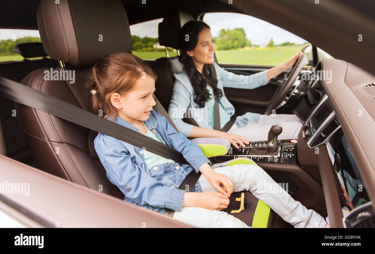 happy woman with little child driving in car Stock Photo - Alamy