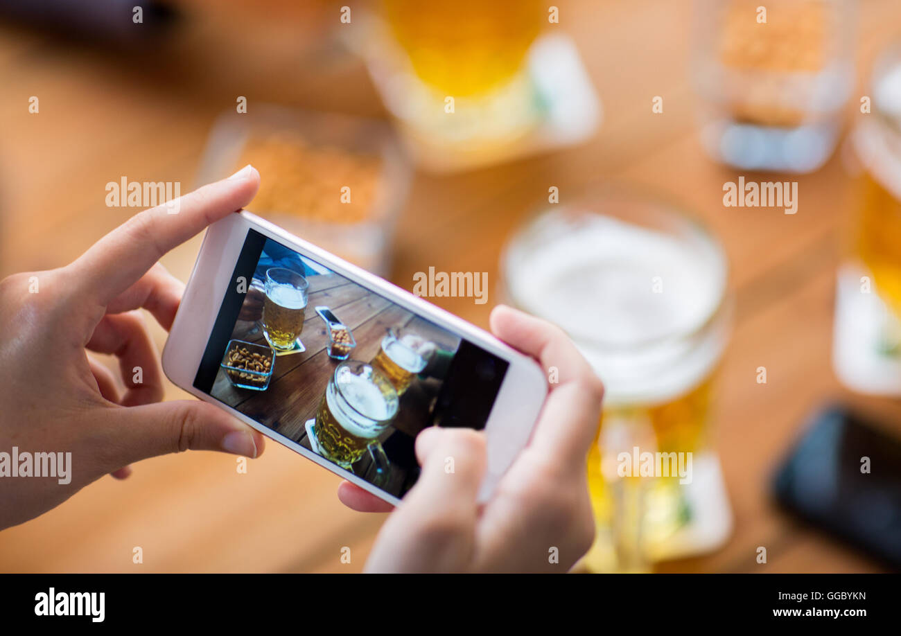close up of hands with smartphone picturing beer Stock Photo - Alamy