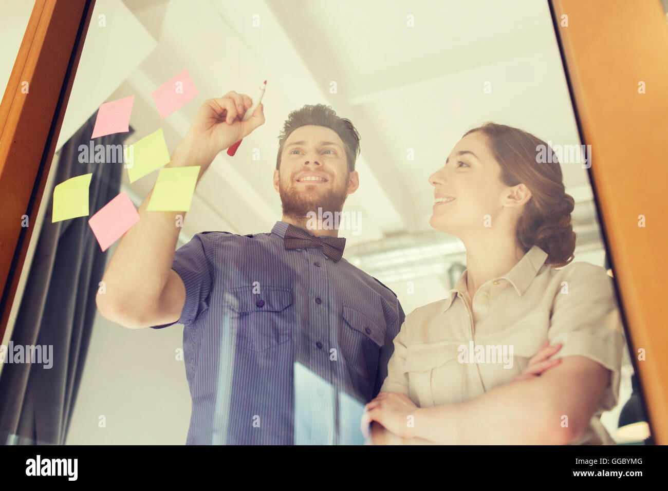 happy creative team writing on blank office glass Stock Photo - Alamy