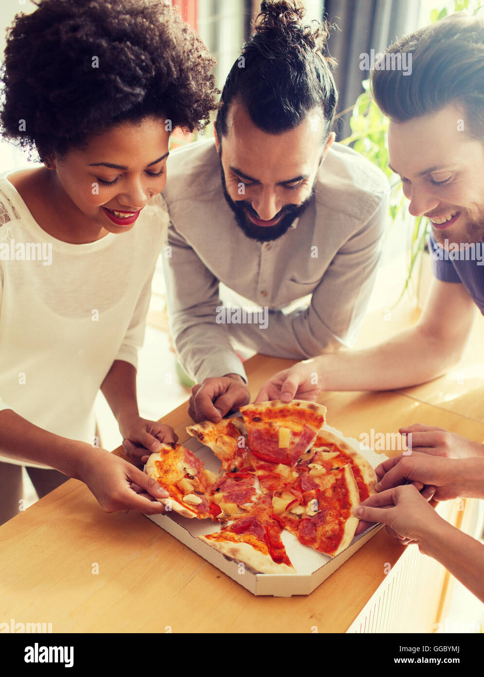 happy business team eating pizza in office Stock Photo - Alamy