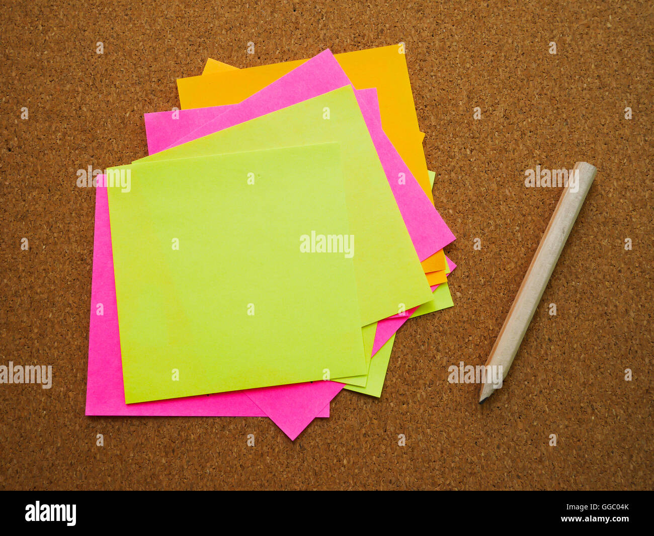Many and colorful post note attach on wood board with wooden pencil ...