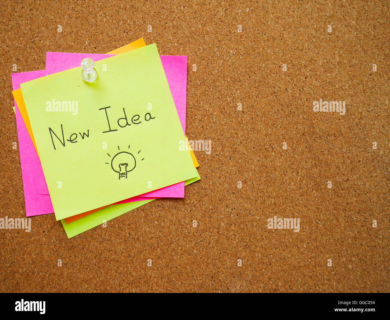 Text new idea in green post note attach by pin on wood board with copy ...