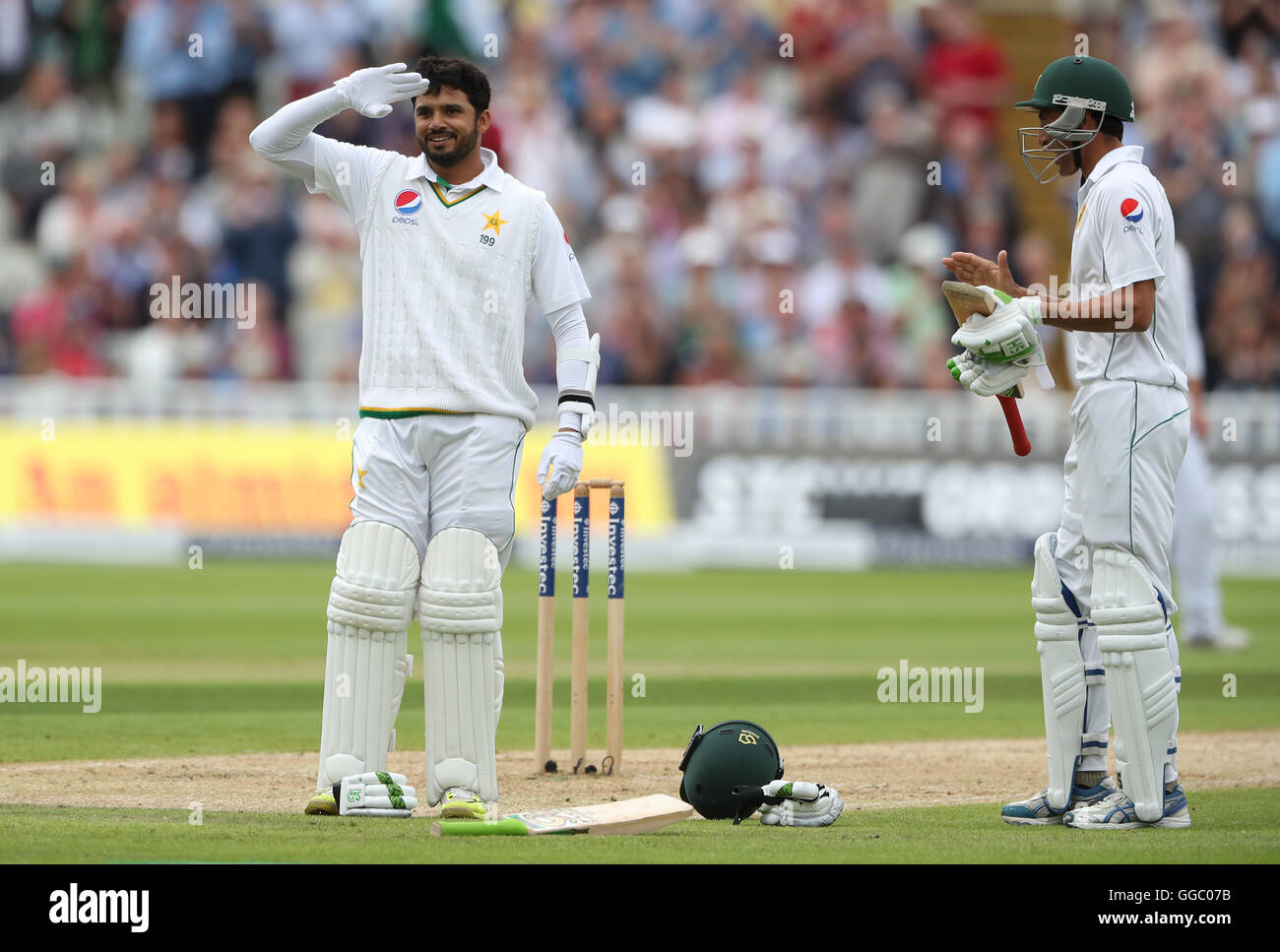 Pakistan batsman Azhar Ali celebrates his 100 not out watched by ...
