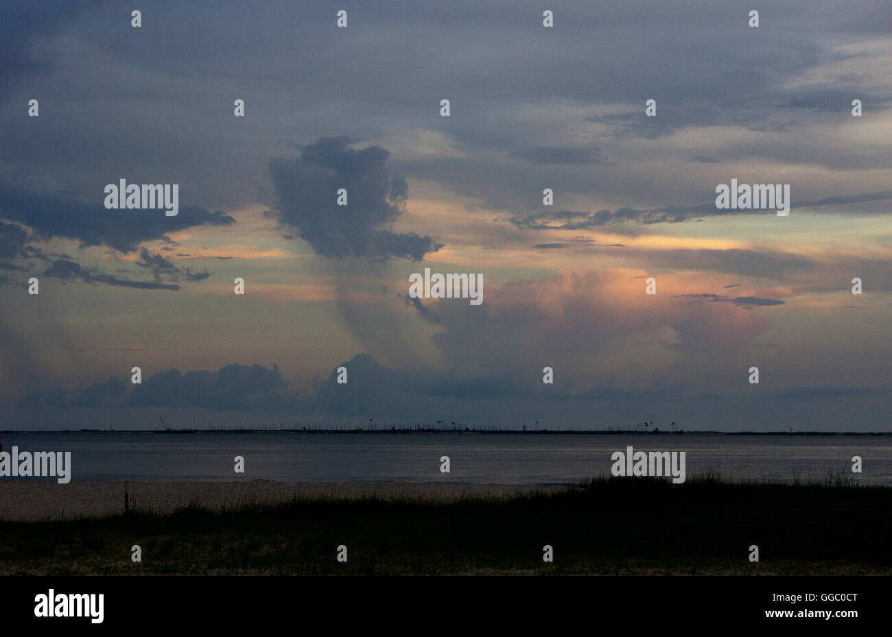 Distant storm over the Gulf of Mexico at sunset Stock Photo - Alamy