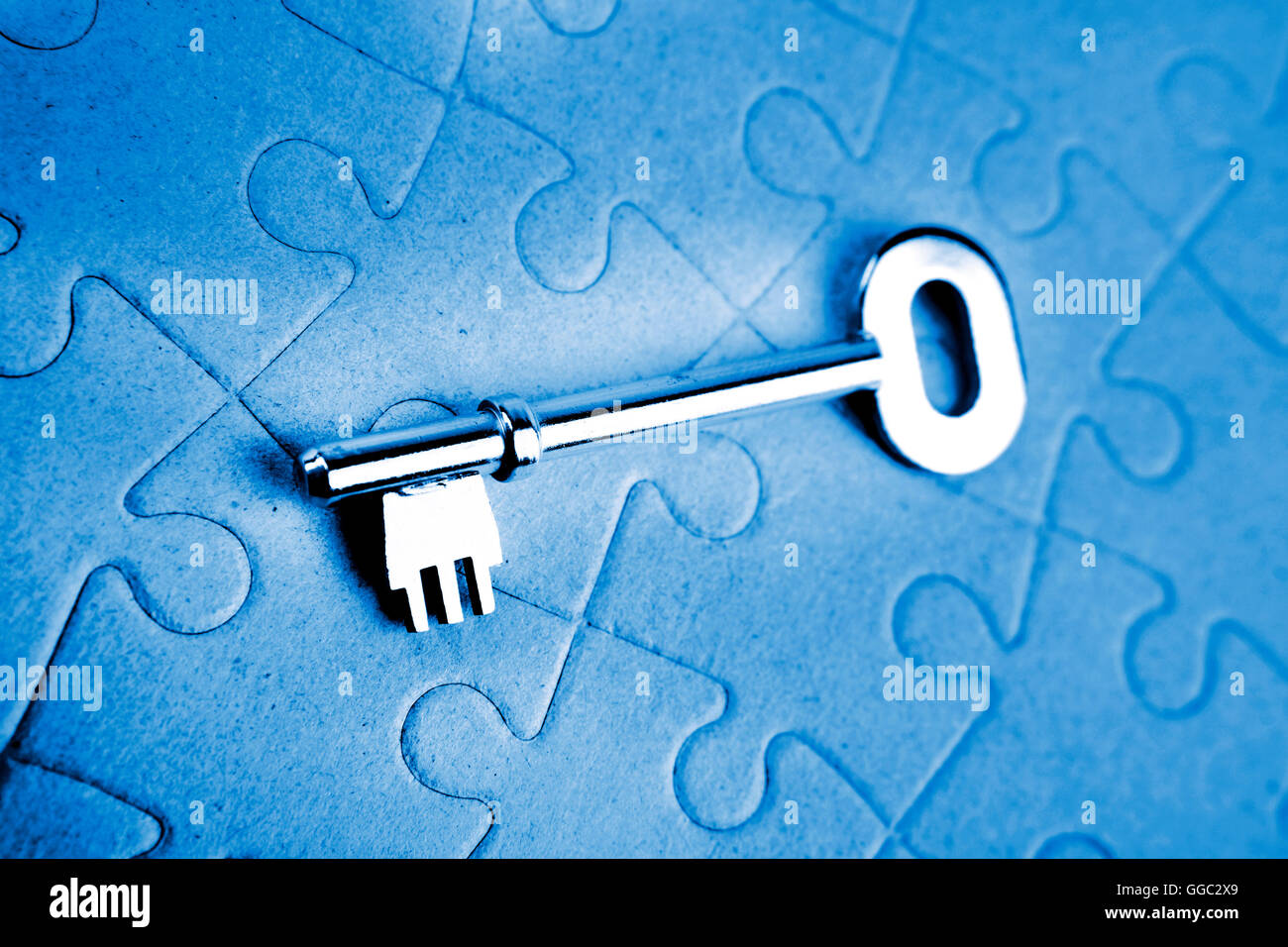 Steel key on jigsaw puzzle Stock Photo - Alamy