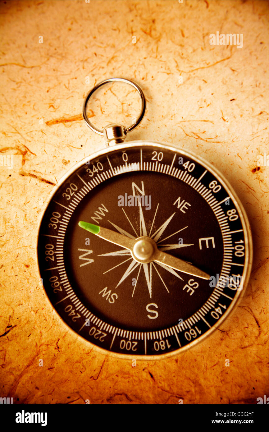 Single compass on brown paper Stock Photo - Alamy