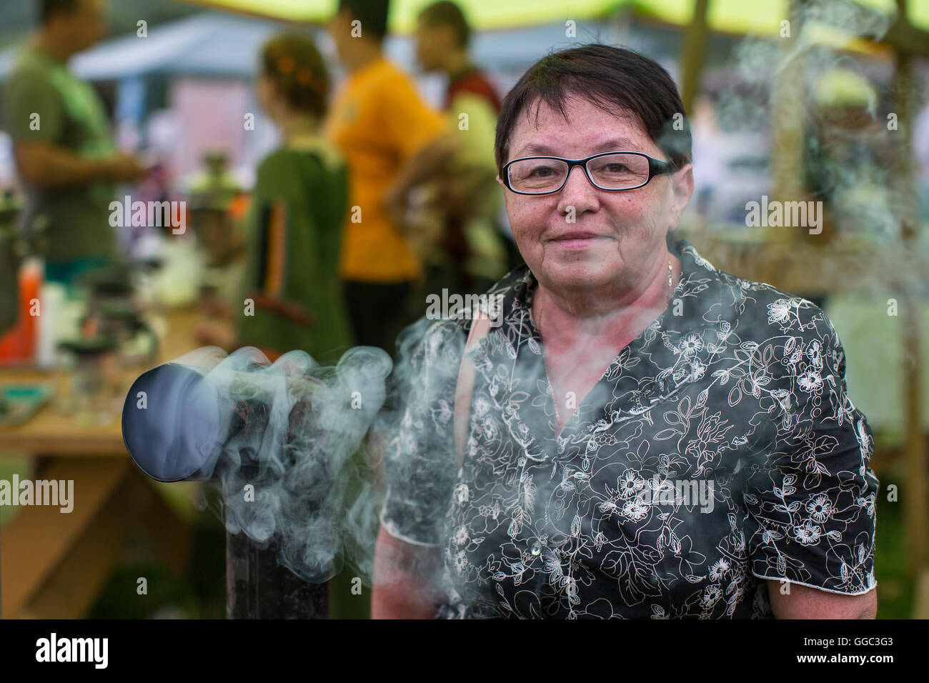 Portrait of a woman at the folk fair near a Smoking samovar Stock Photo ...