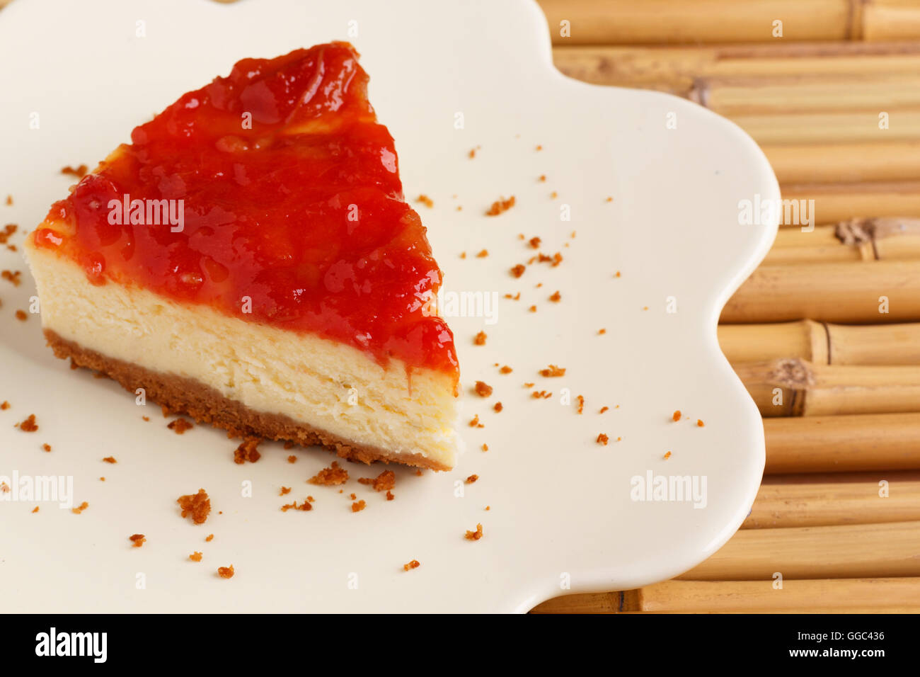 Cheesecake with brazilian goiabada jam of guava on plate on bamboo ...