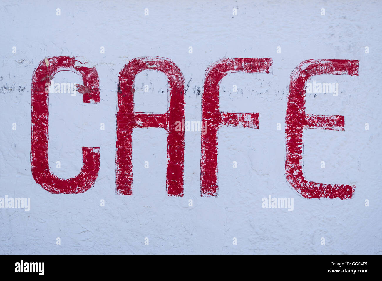 Cafe word painted in eroded red letter on a white wall Stock Photo - Alamy