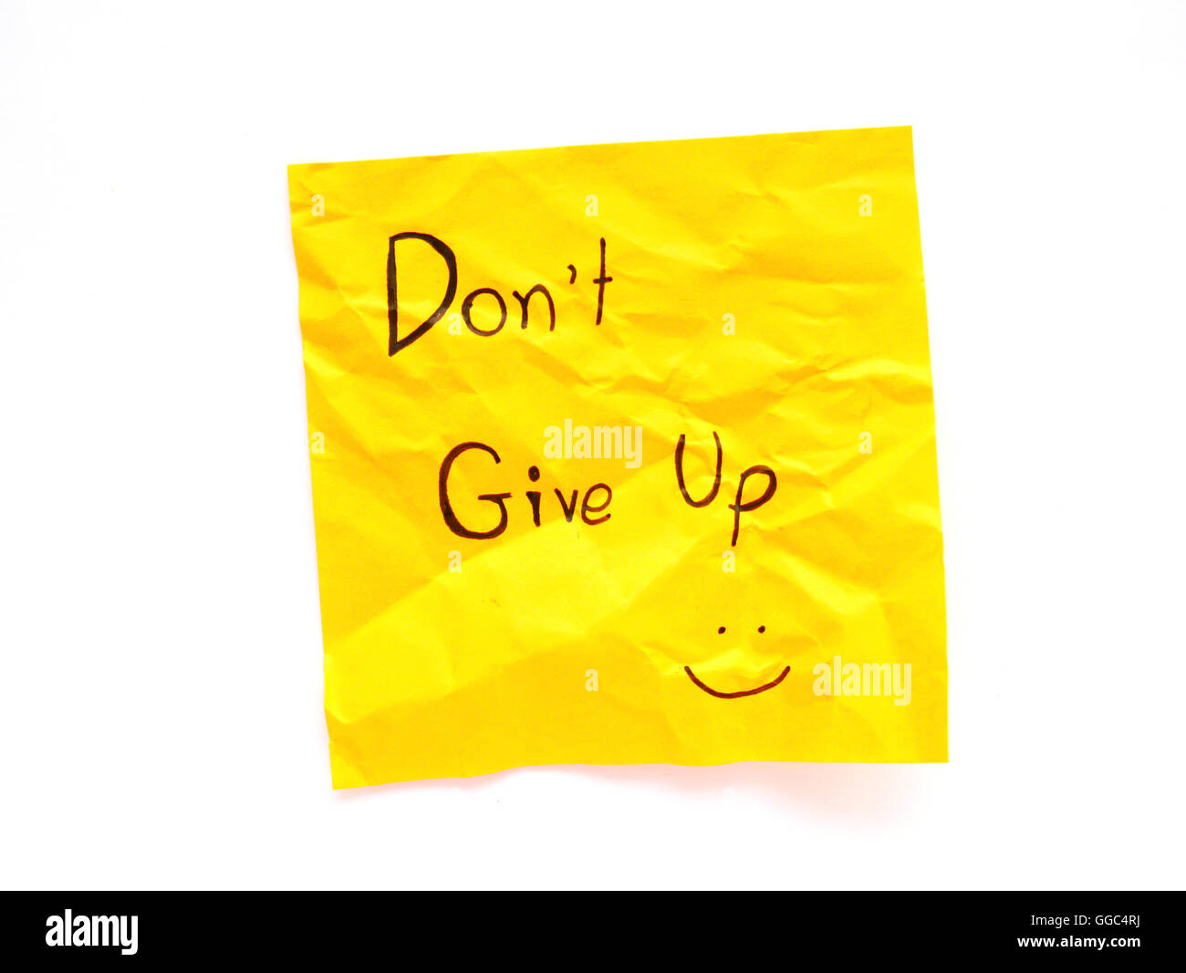 Write don't give up on yellow post note isolated on white background ...