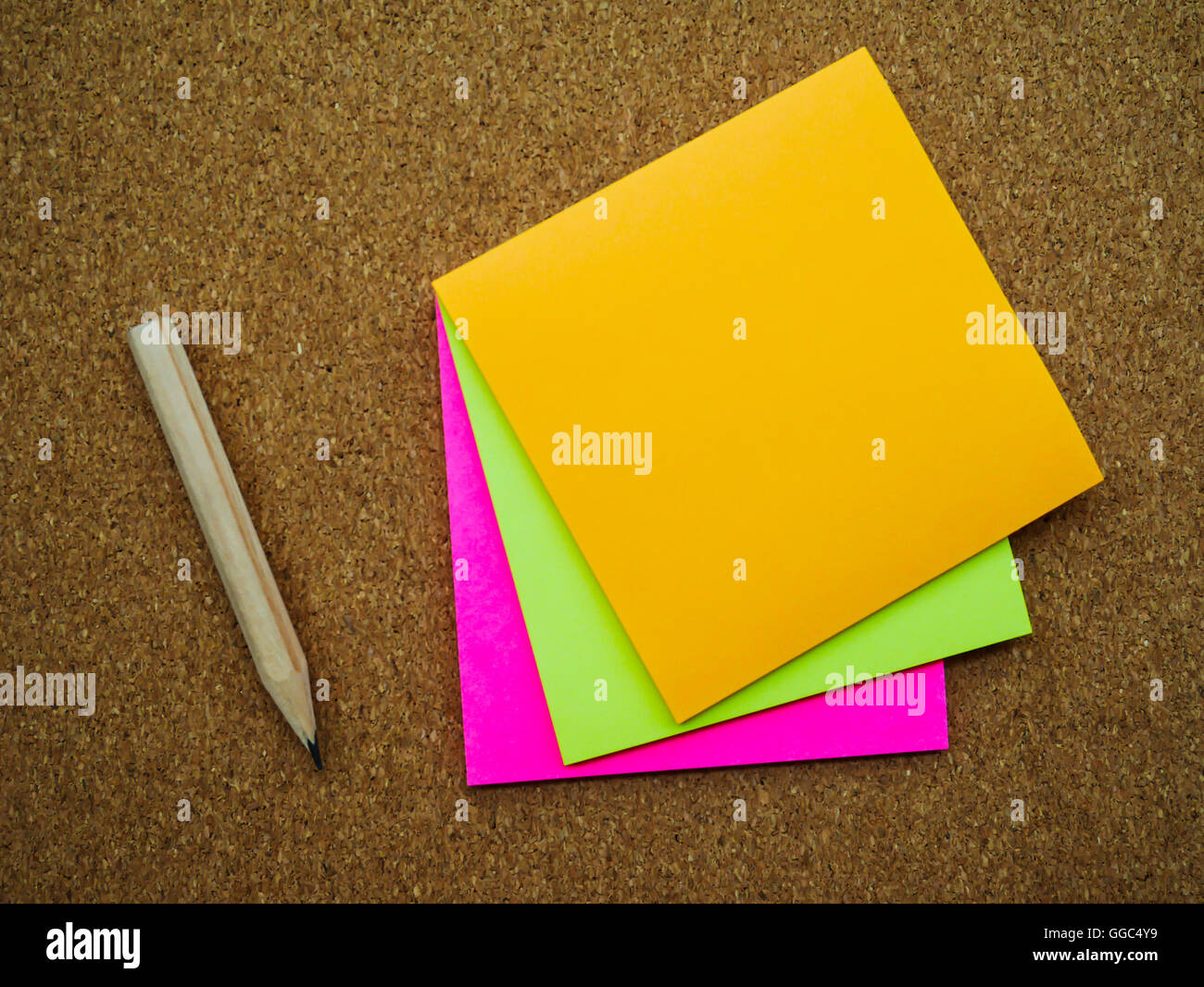 Three post note and pencil on wooden board Stock Photo - Alamy